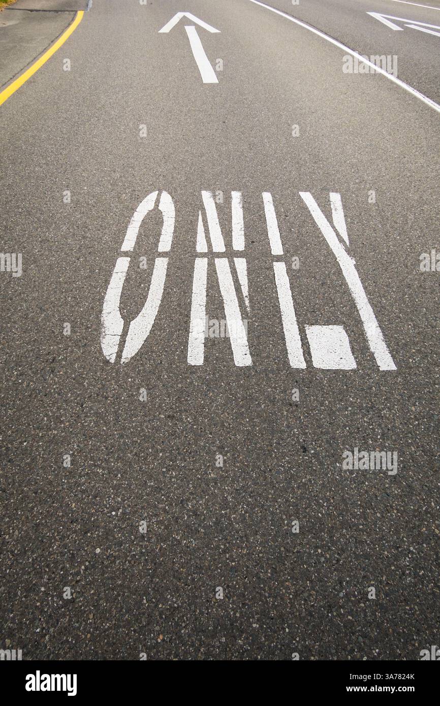 This way only road, Ahead Only with arrow symbols painted on the road ...