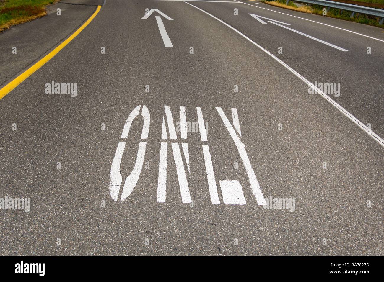 This way only road, Ahead Only with arrow symbols painted on the road ...