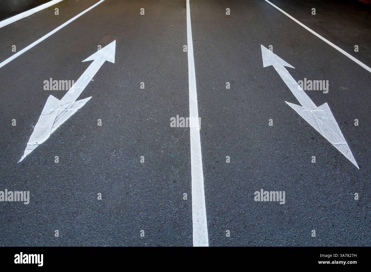 Two traffic arrow symbols on the road surface, pointed at both ends, on ...