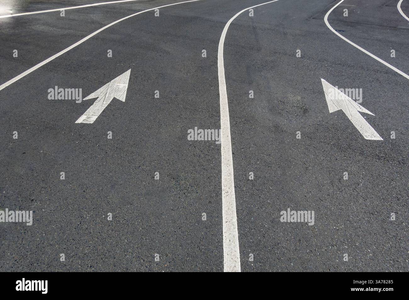 Two directional Arrow symbols on the road surface, on a city road in ...