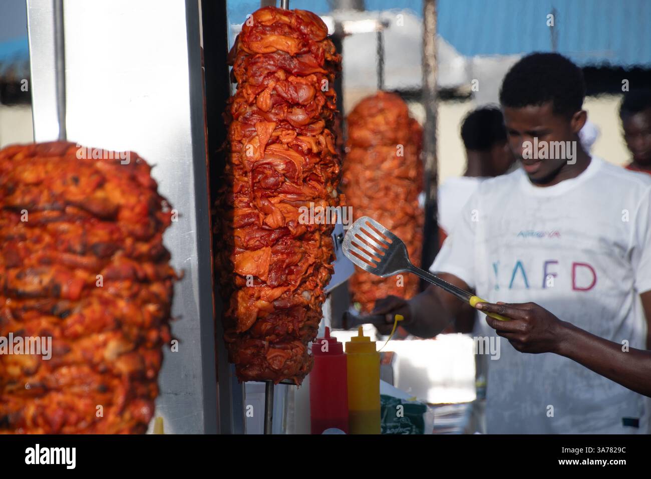 Juicy shawarma cooking on a vertical spit at a local Zanzibar food ...