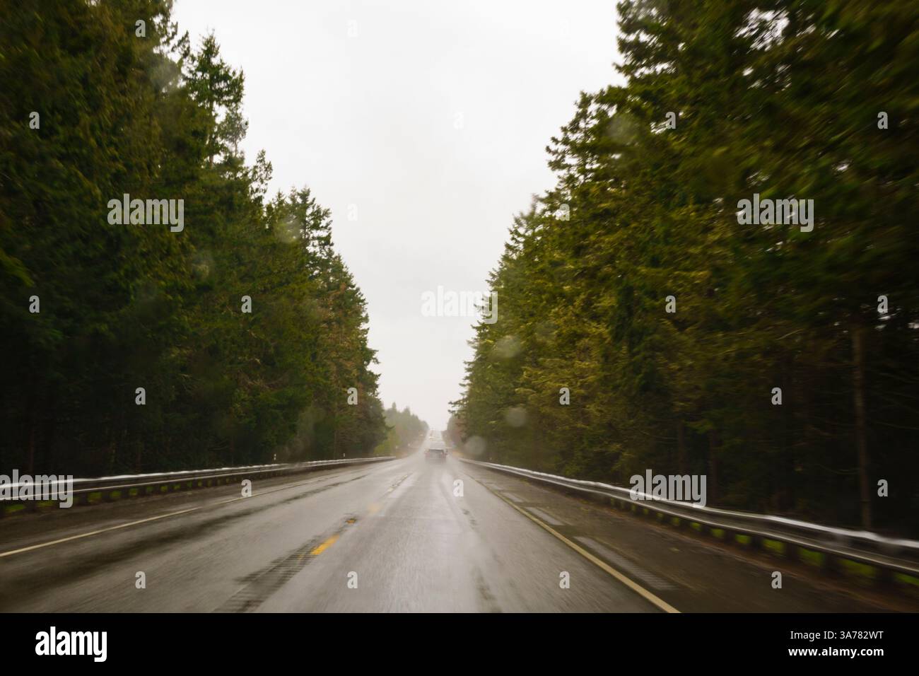 Driver's view through windshield of wet highway in rural area, WA, USA ...