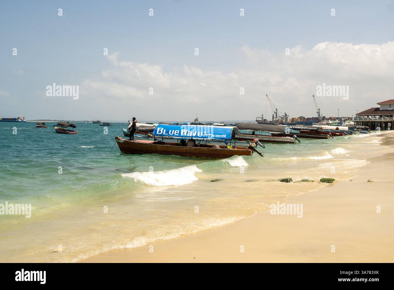 Traditional wooden fishing boats resting on the shores of Zanzibar’s ...