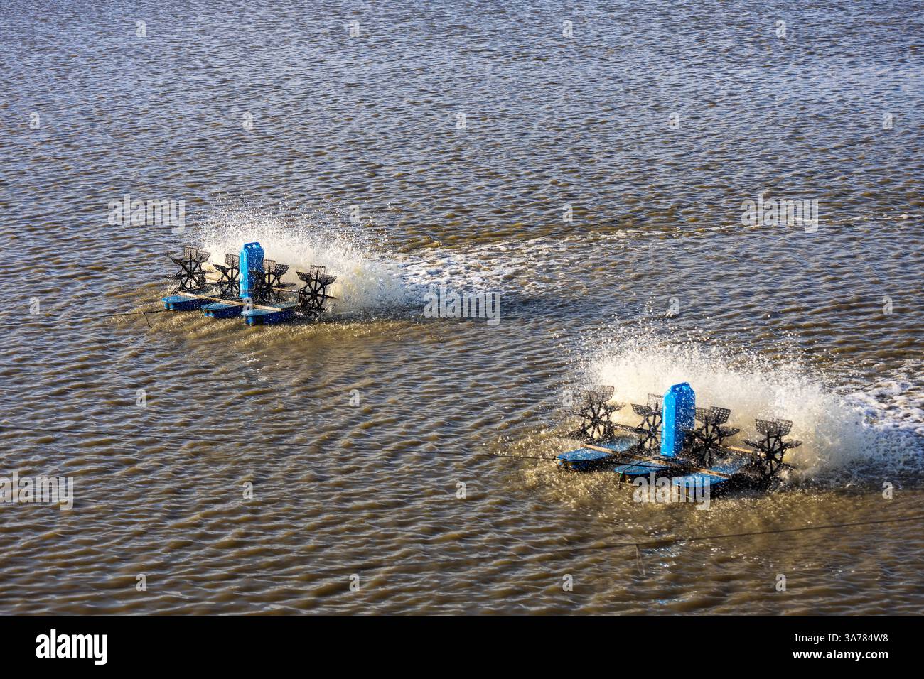 Two water aerators creating splashes in a lake Stock Photo - Alamy