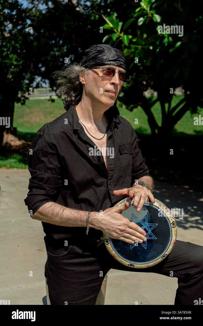 Portrait of a percussionist playing his derbake or darbuka Stock Photo ...