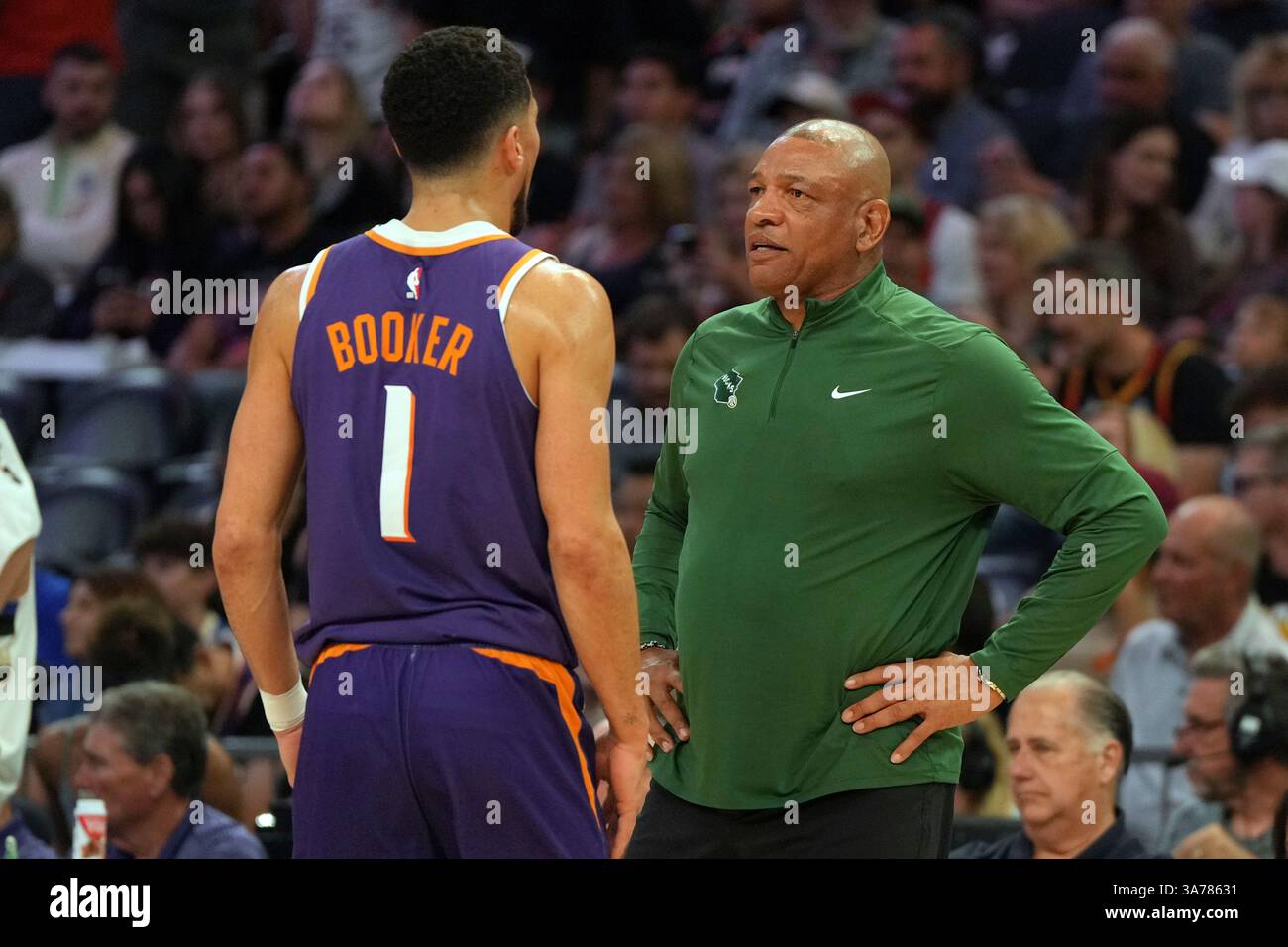 Phoenix Suns guard Devin Booker (1) talks to Milwaukee Bucks head coach ...