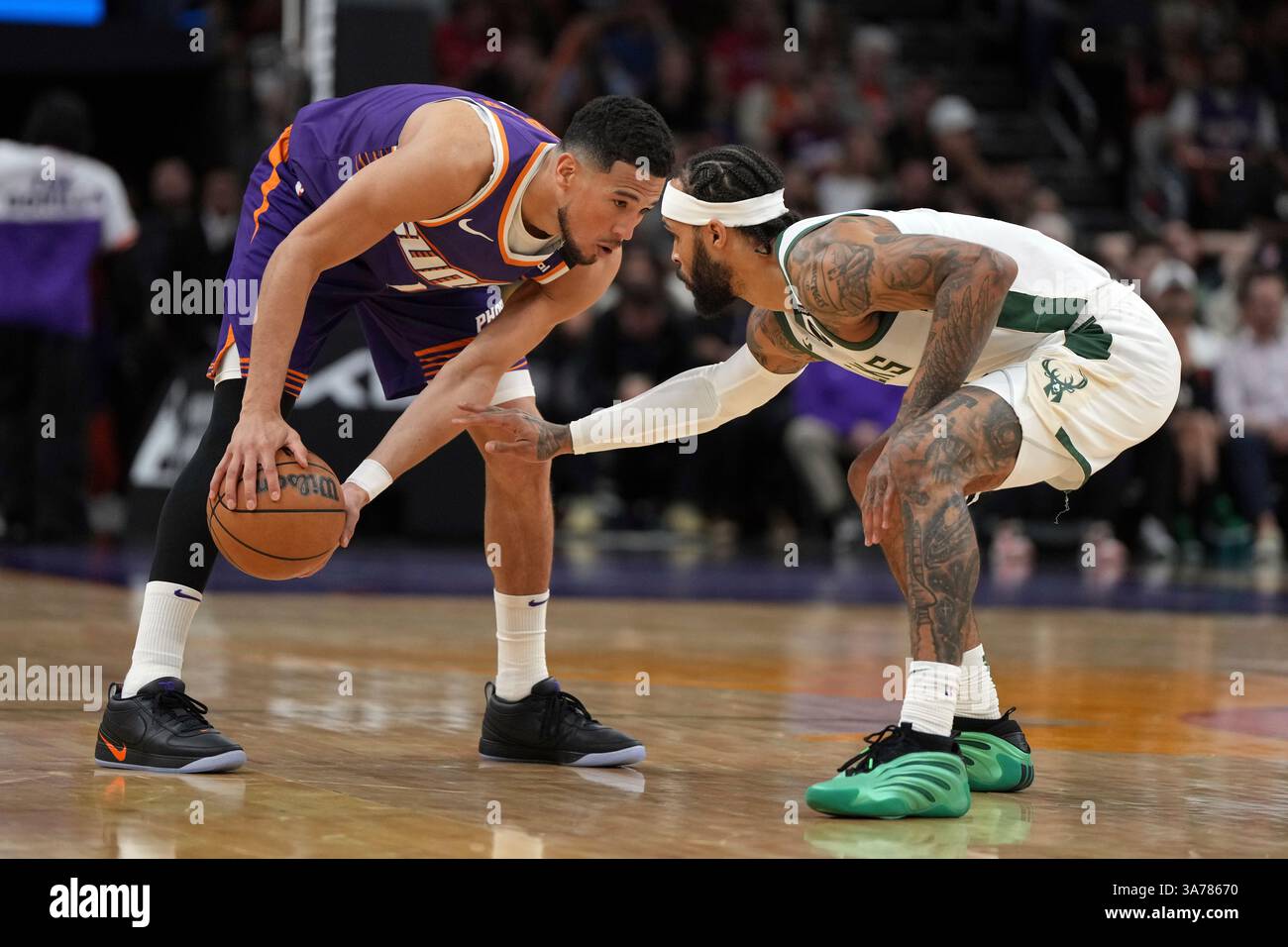 Phoenix Suns guard Devin Booker (1) and Milwaukee Bucks guard Gary ...