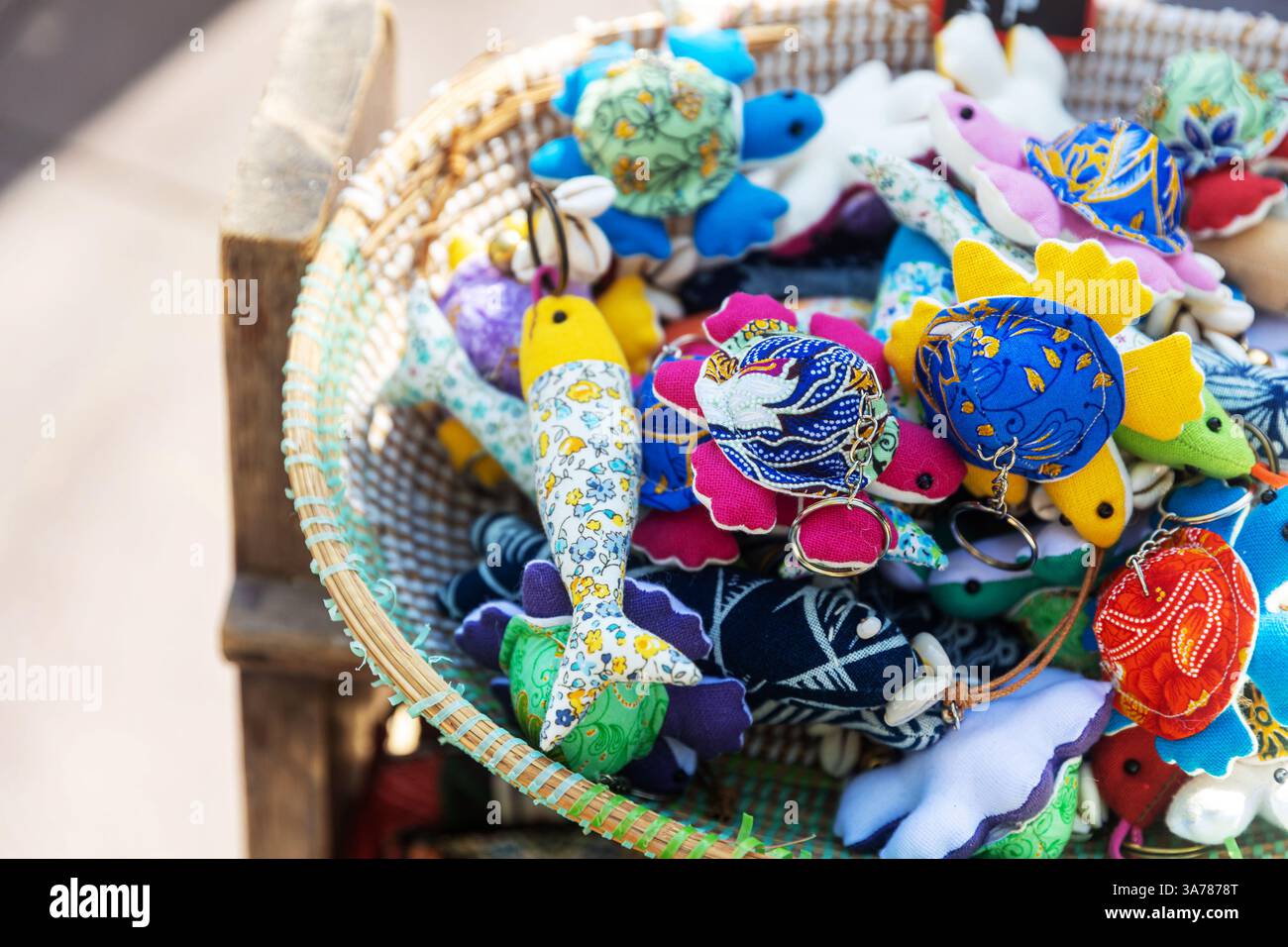 Colorful handmade fish and turtle keychains in a woven basket Stock ...
