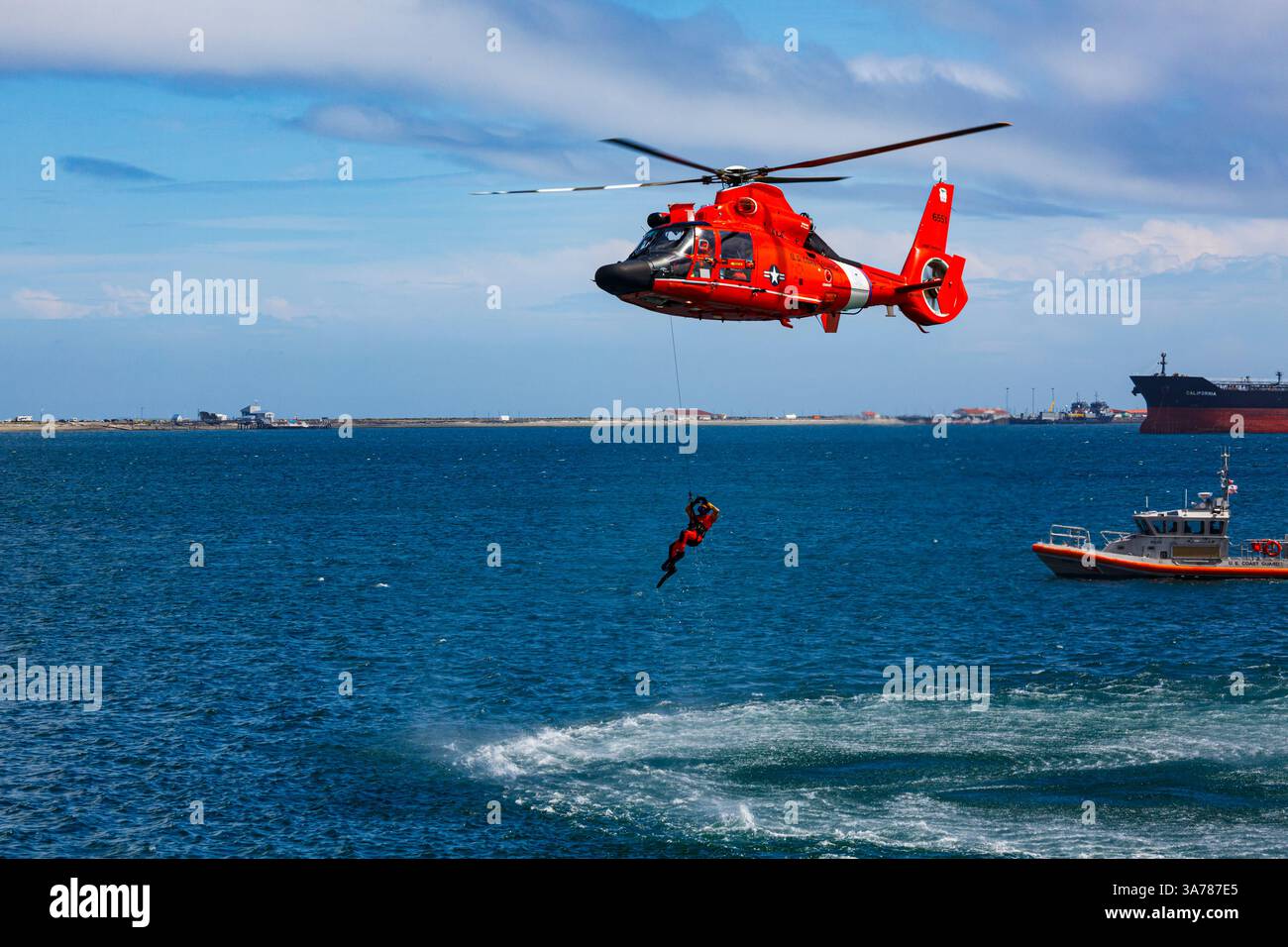 US Coast Guard helicopter hovering over the water in a demo of a rescue ...