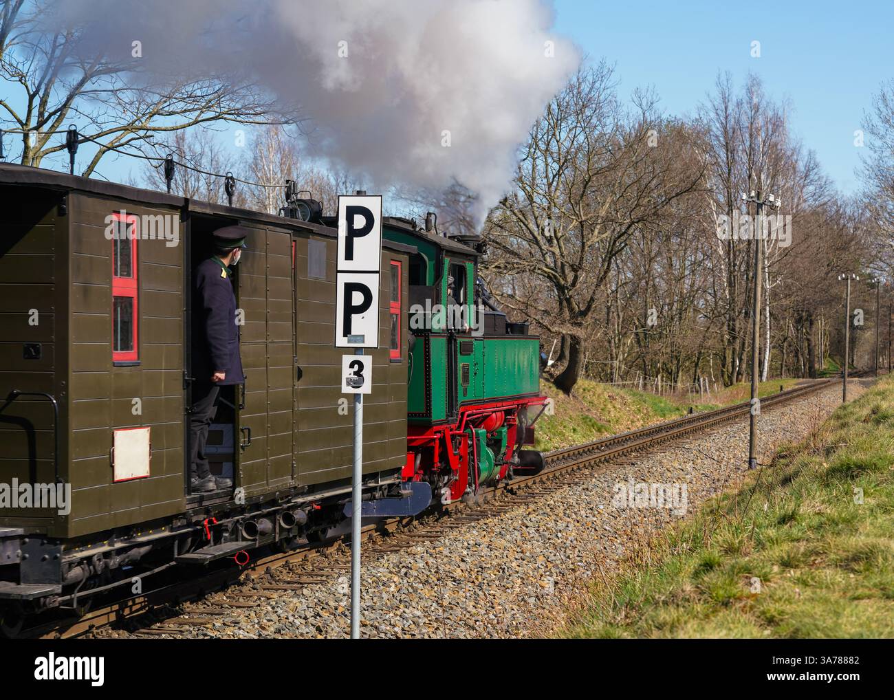 Tourist steam train moves on narrow gauge tracks in city Grosser Garten ...