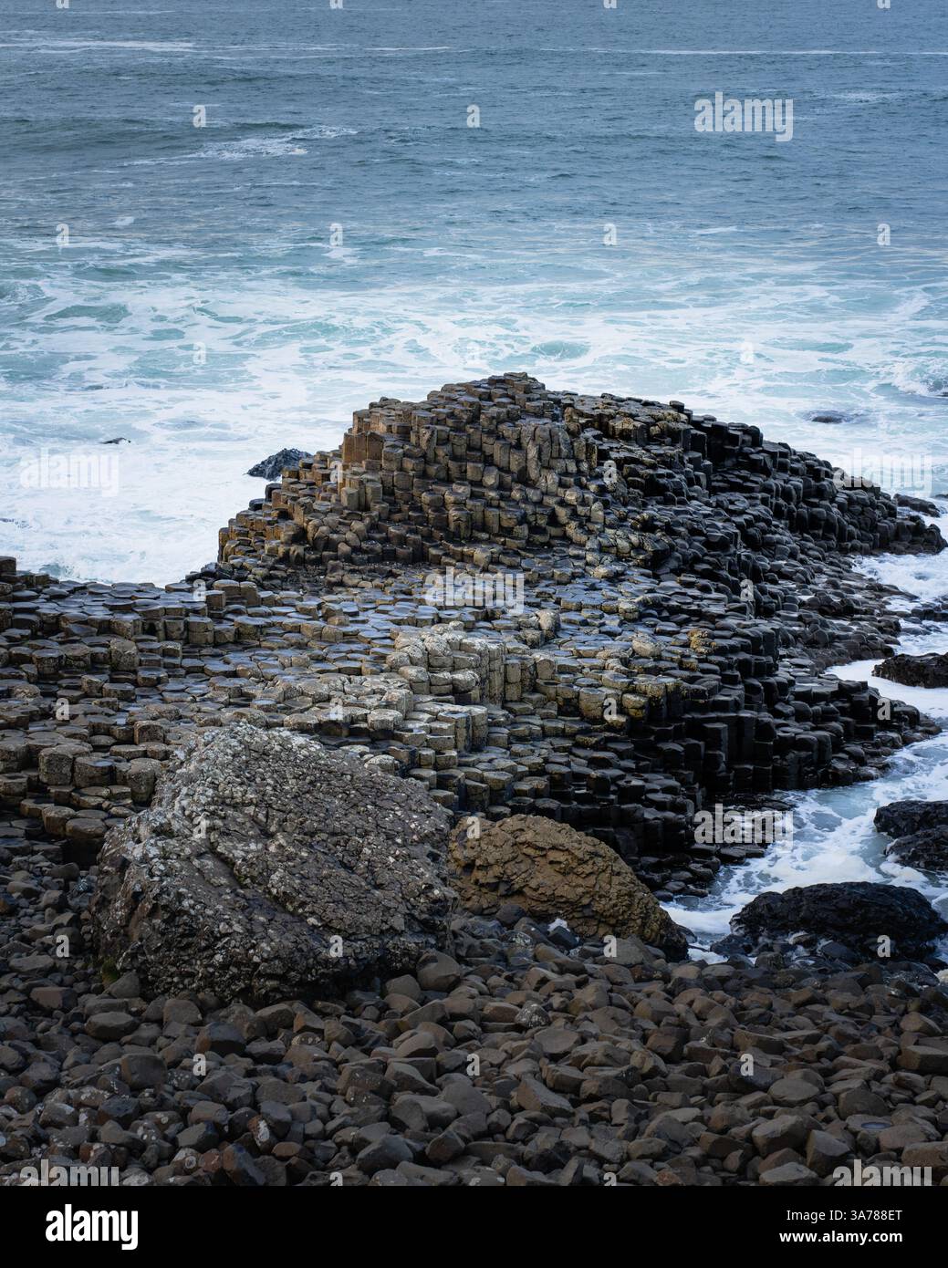 The striking basalt formations of the Giant's Causeway meeting the wild ...