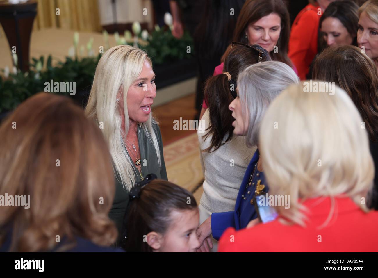 Rep. Marjorie Taylor Greene, left, talks with Sen. Joni Ernst at a ...