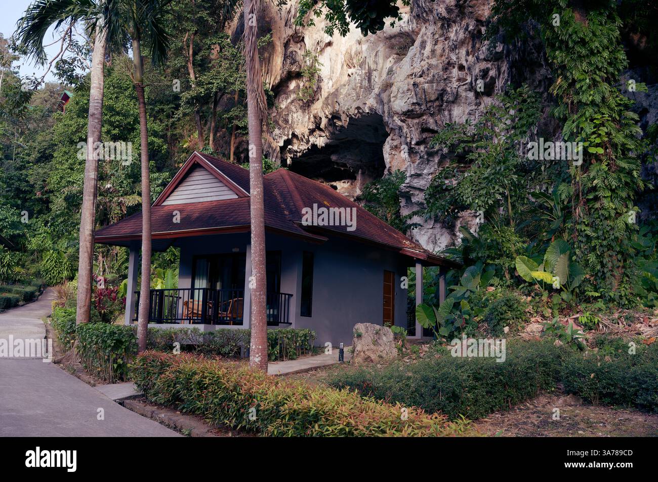 Cozy tropical bungalow nestled beneath limestone cliffs in the lush ...