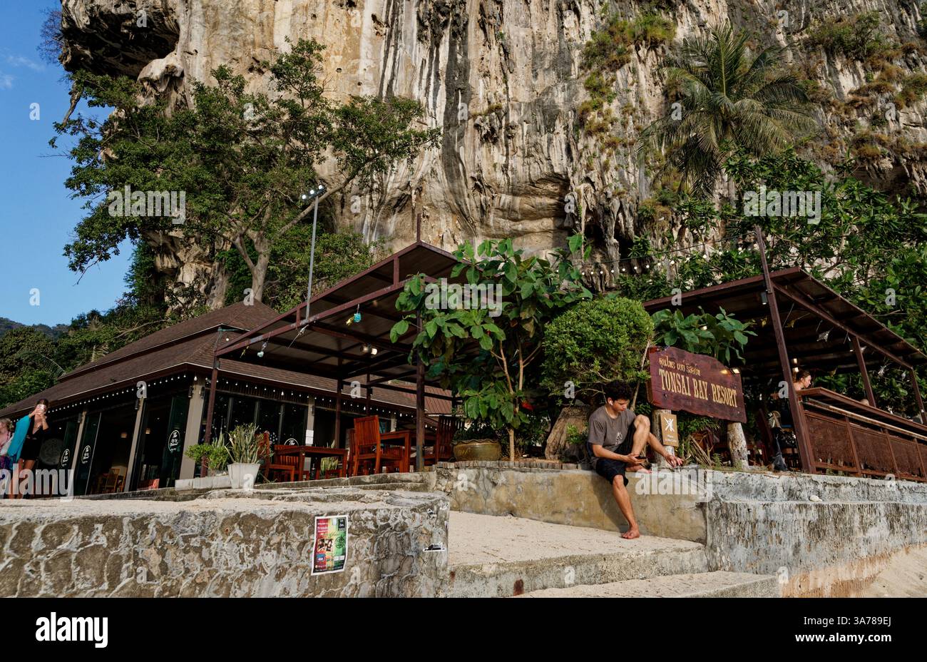 Tonsai Bay Resort tucked beneath towering limestone cliffs Stock Photo ...