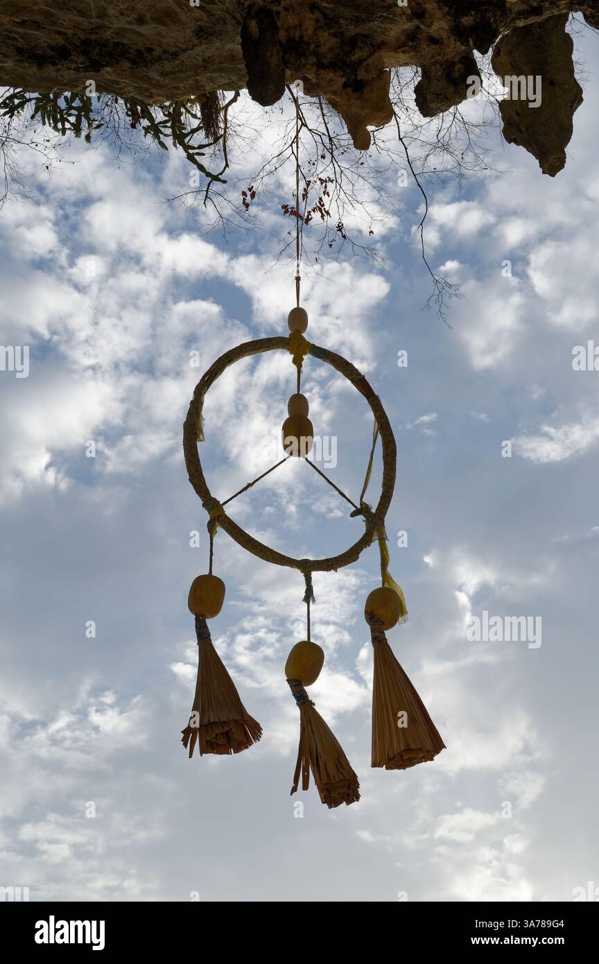 A handmade peace symbol sways from the limestone cliffs of Tonsai Stock ...