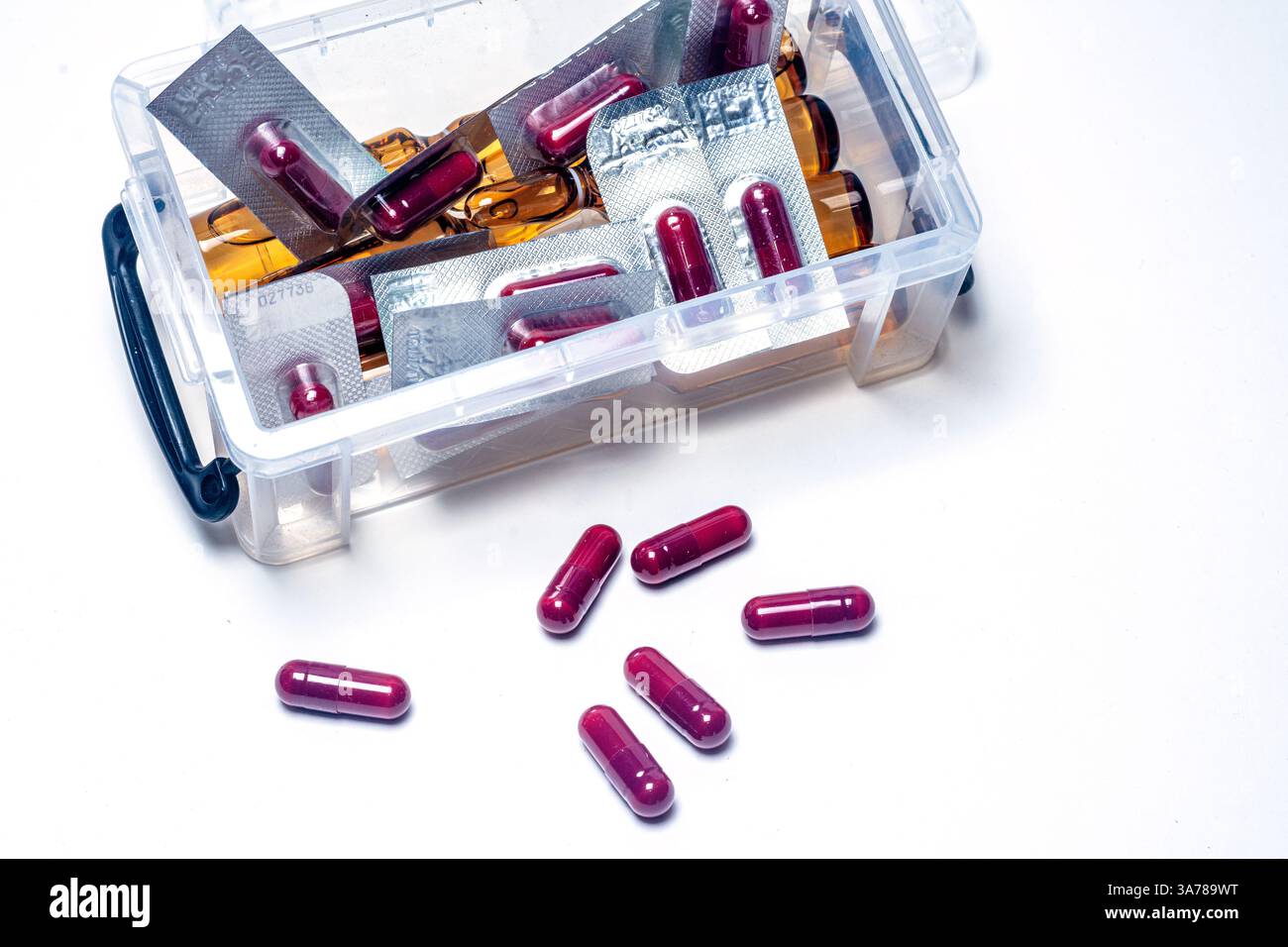 Red pills spilling from blister pack in transparent plastic box Stock ...