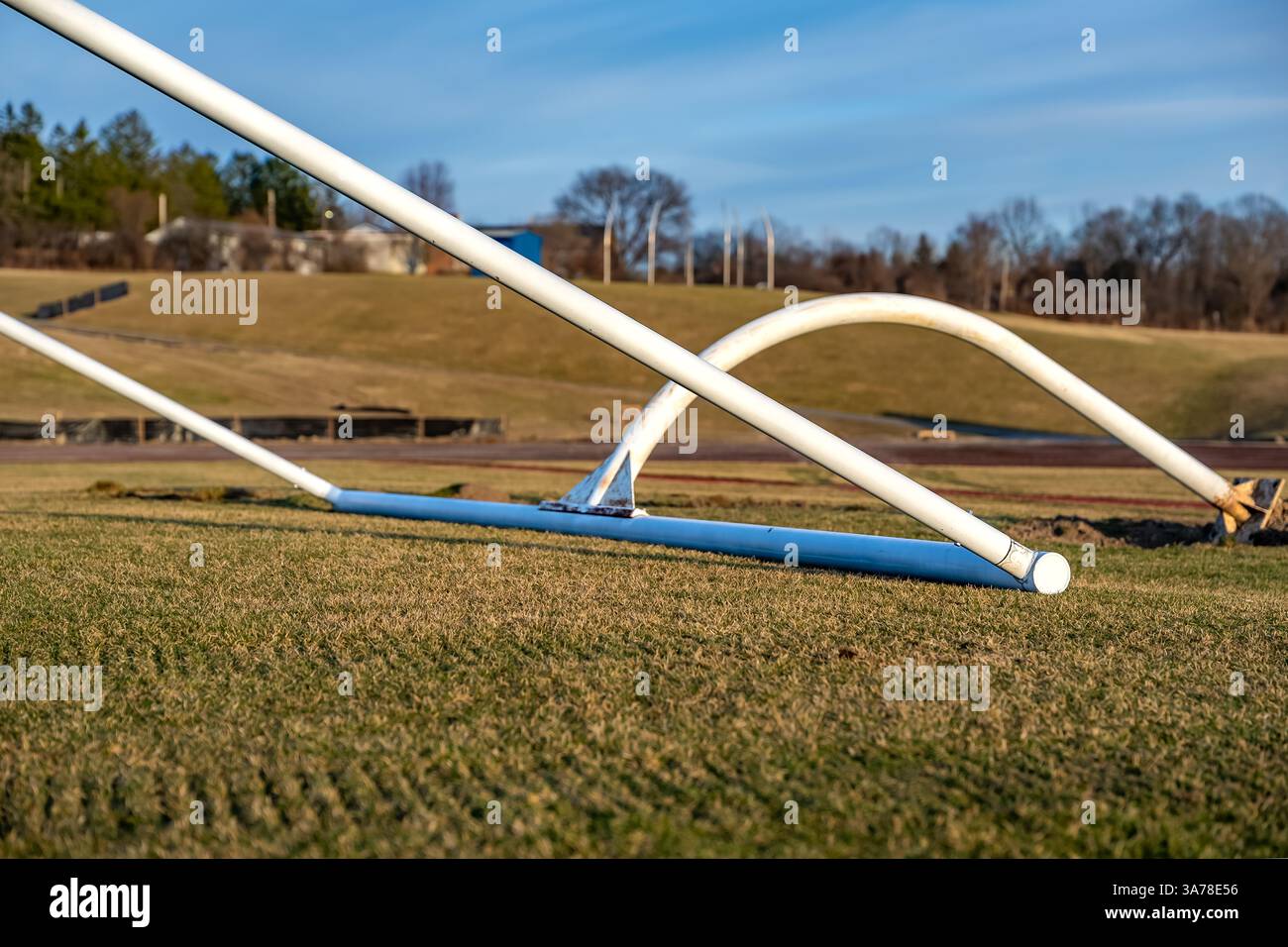 Removal, damaged, of a white american football goal post on a natural ...