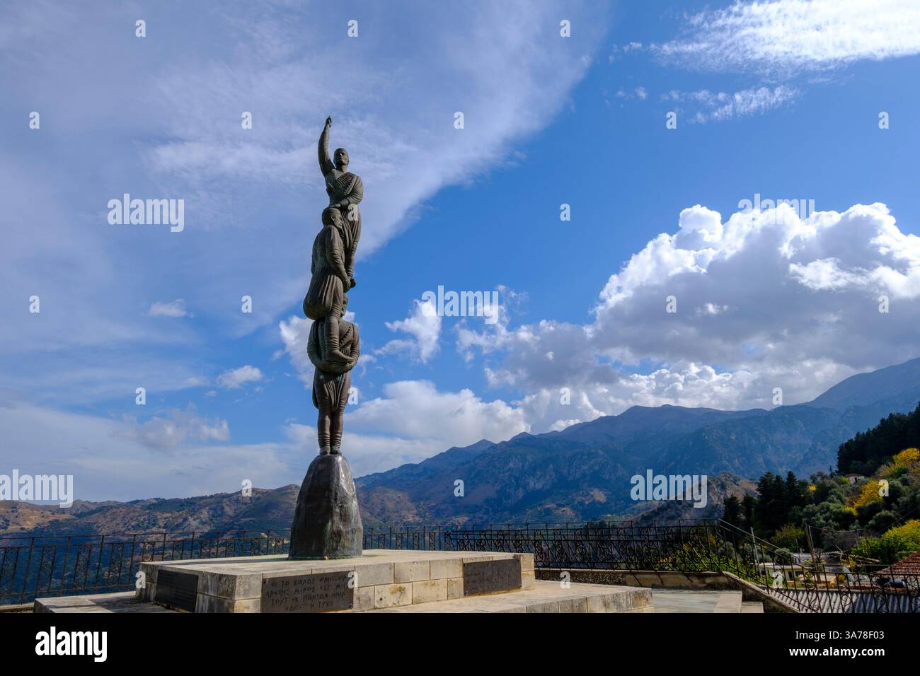 Here's a caption describing the image: This is a statue depicting three ...