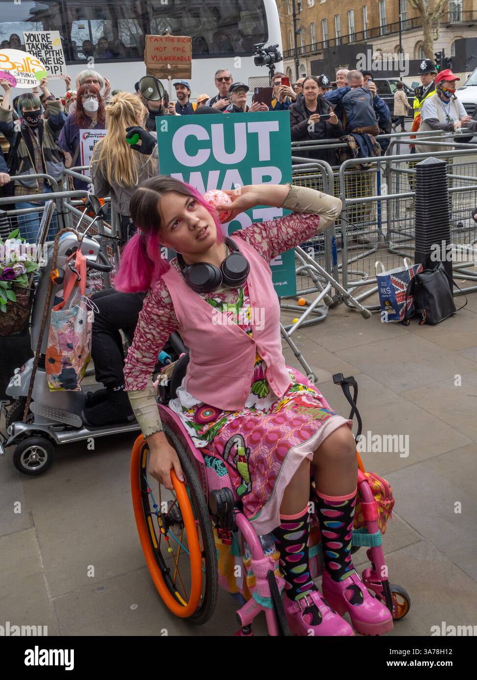 London, UK. 26 Mar 2025. A woman in a wheelchiar prepares to throw a ...