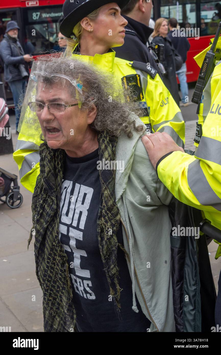 London, UK. 26 Mar 2025. Police hold an arrested protester Disabled ...
