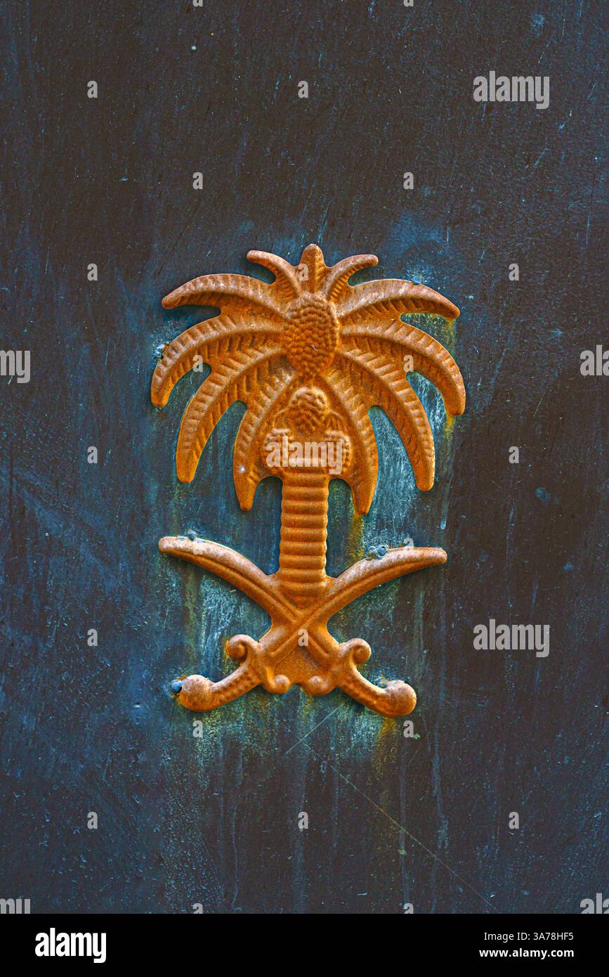 A close view of golden emblem of Saudi Arabia printed on metal, Jeddah ...