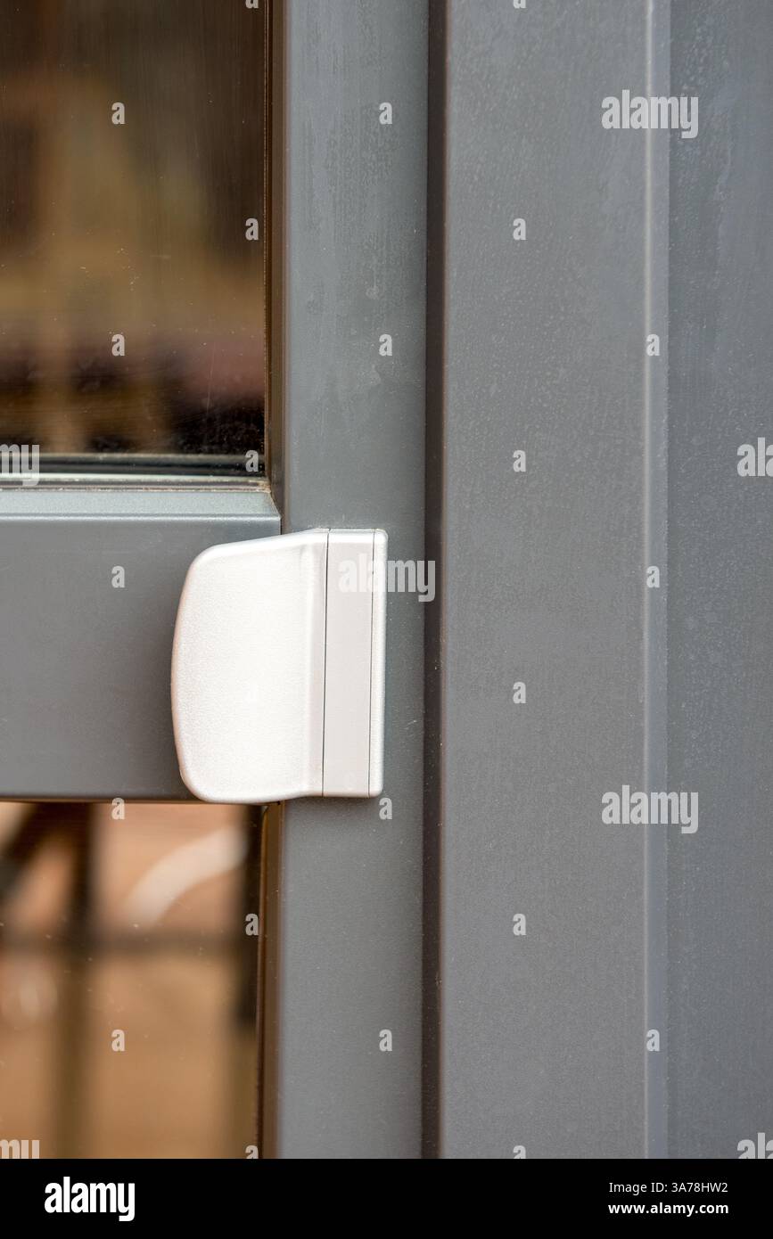 modern metal door handle on a modern gray frame of a door frame Stock ...