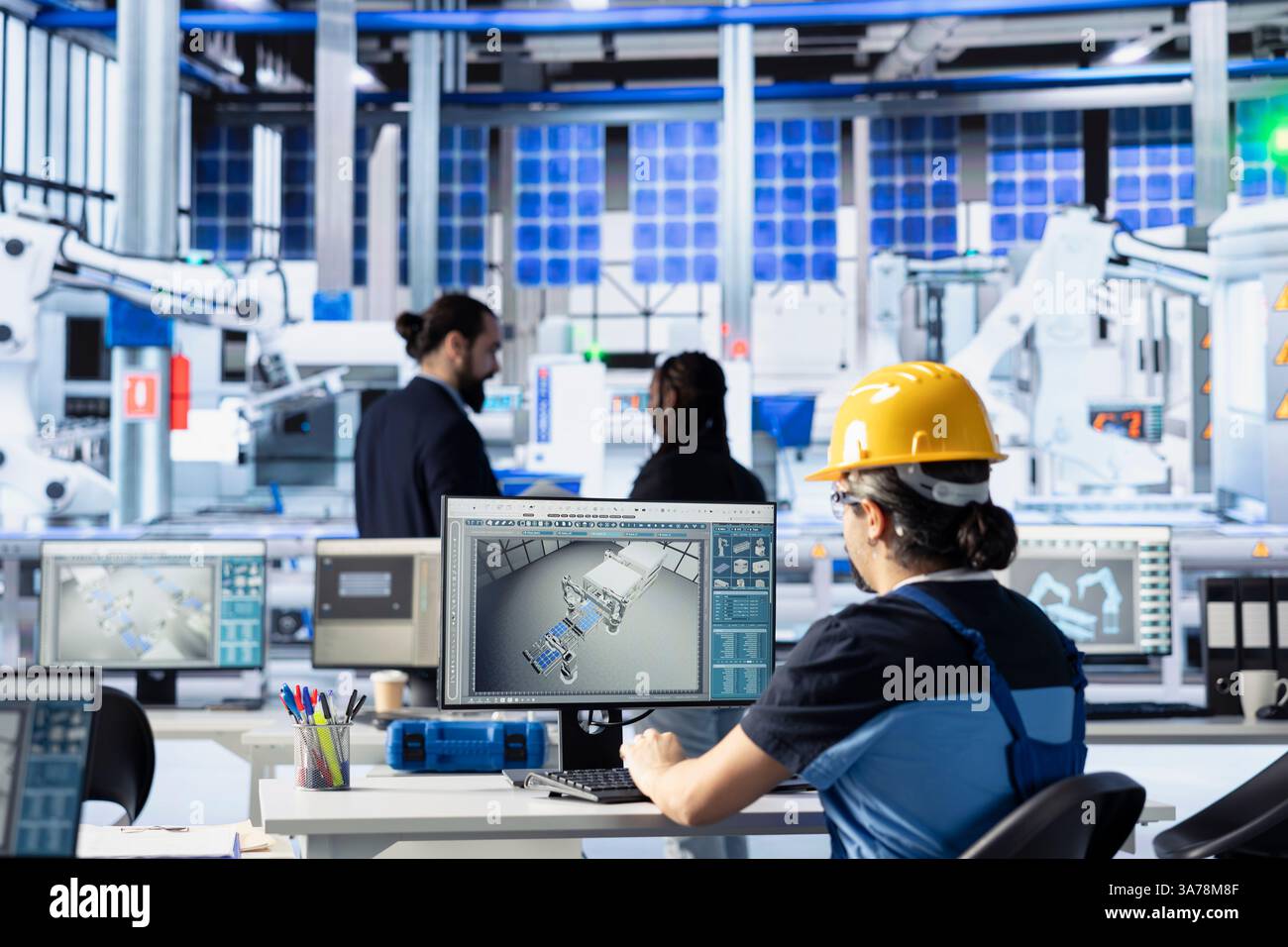 Engineer in solar technology factory reviewing system logs on computer to identify operational ...