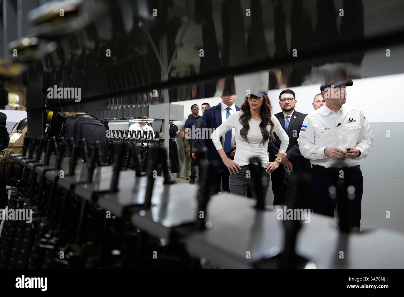 Homeland Security Secretary Kristi Noem looks at weapons during a tour ...