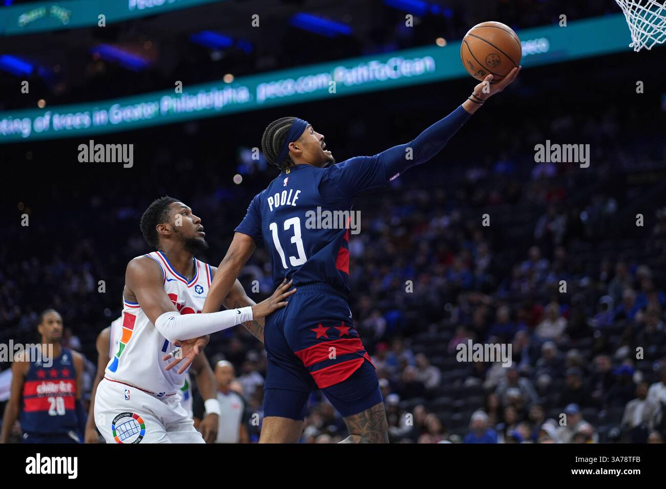 Washington Wizards' Jordan Poole, right, goes up for a shot against ...