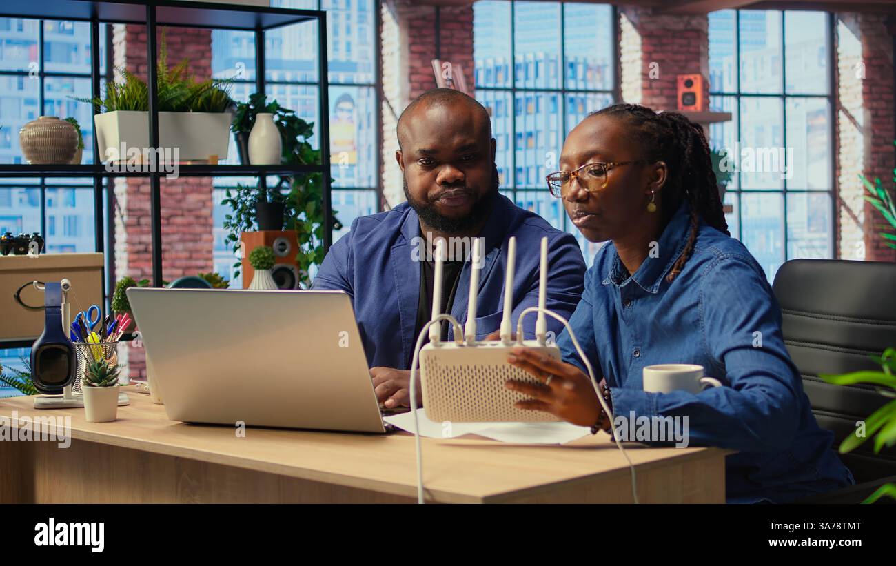 African American couple at home office troubleshooting their Wi Fi ...