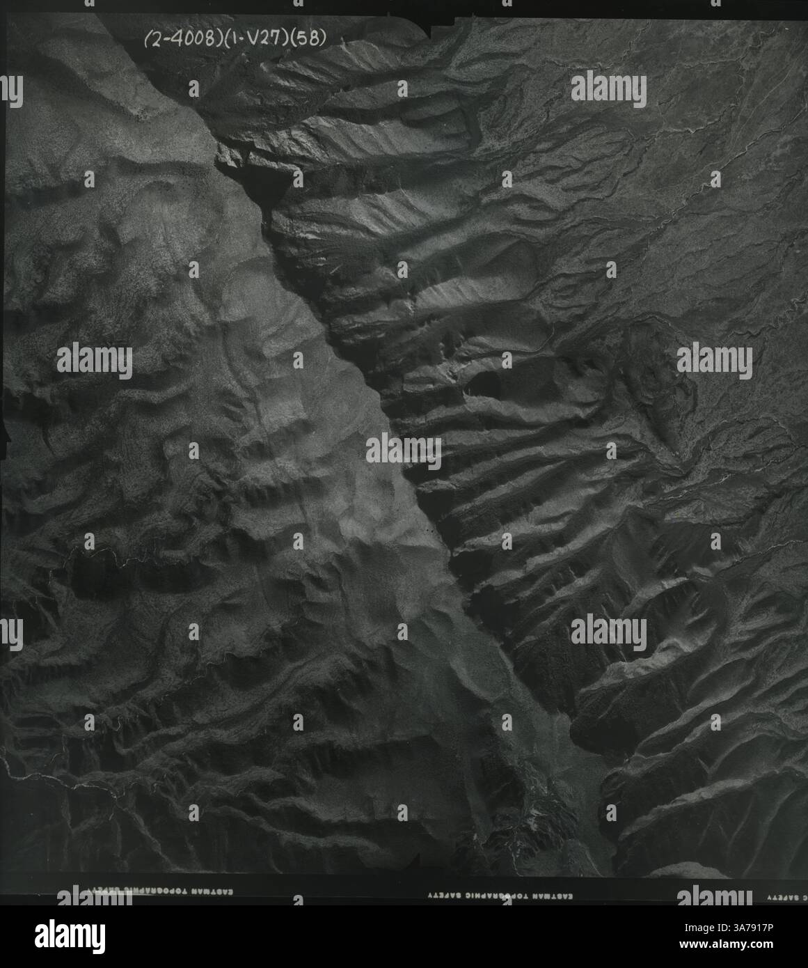 Steep canyon walls and tributary gullies are seen in this vertical ...