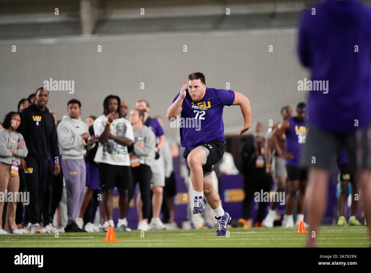 LSU offensive lineman Garrett Dellinger runs through drills during the ...