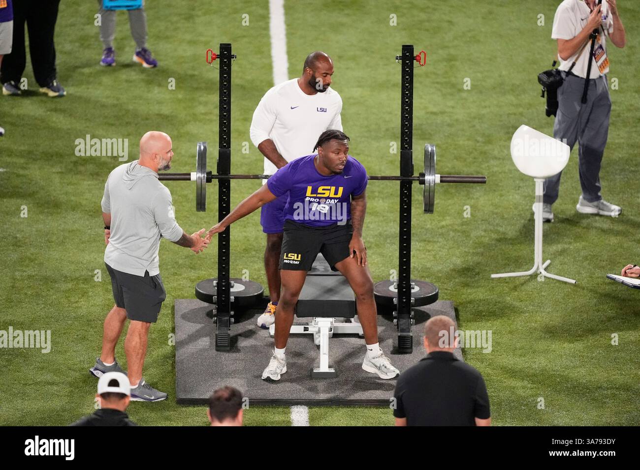 LSU linebacker Greg Penn III reacts after performing the bench ...