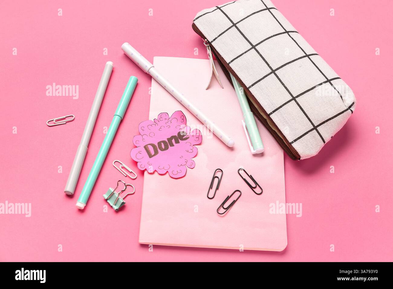 Sticky note with word DONE and stationery on pink background Stock ...