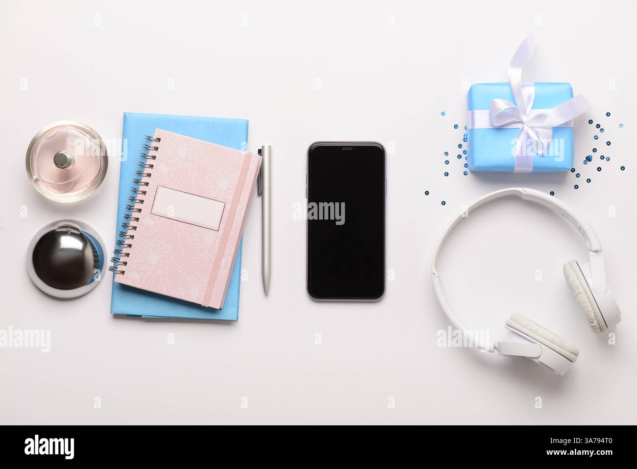 Composition with modern mobile phone, notebooks, headphones and gift ...