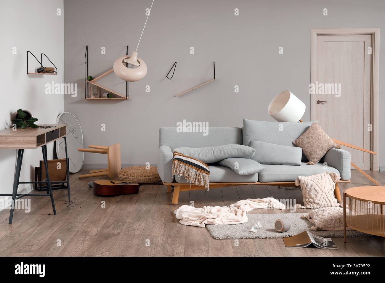 Interior of messy living room with sofa, shelves and tables Stock Photo ...