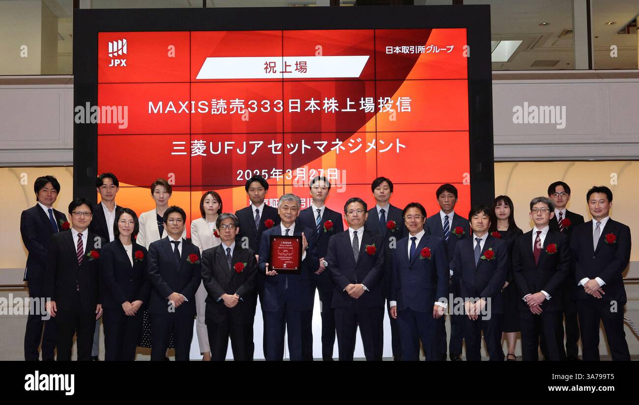 Mitsubishi UFJ Asset Management and Yomiuri Shimbun officials pose for a commemorative ...