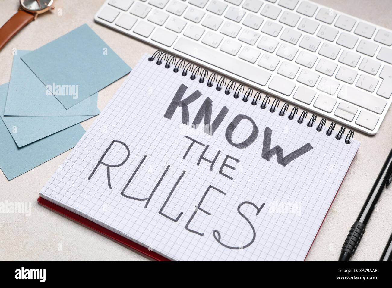 Notebook with text KNOW THE RULES, sticky notes and computer keyboard ...