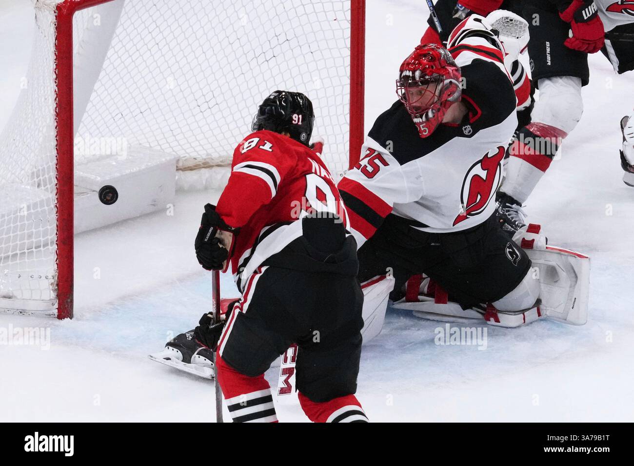 New Jersey Devils goaltender Jacob Markstrom can't stop a goal by Chicago Blackhawks center ...