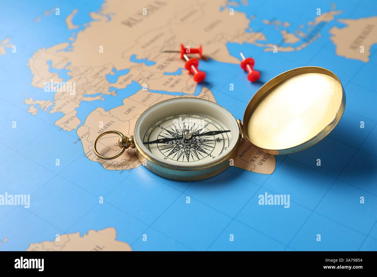 Compass with pins on map, closeup. Itinerary concept Stock Photo - Alamy
