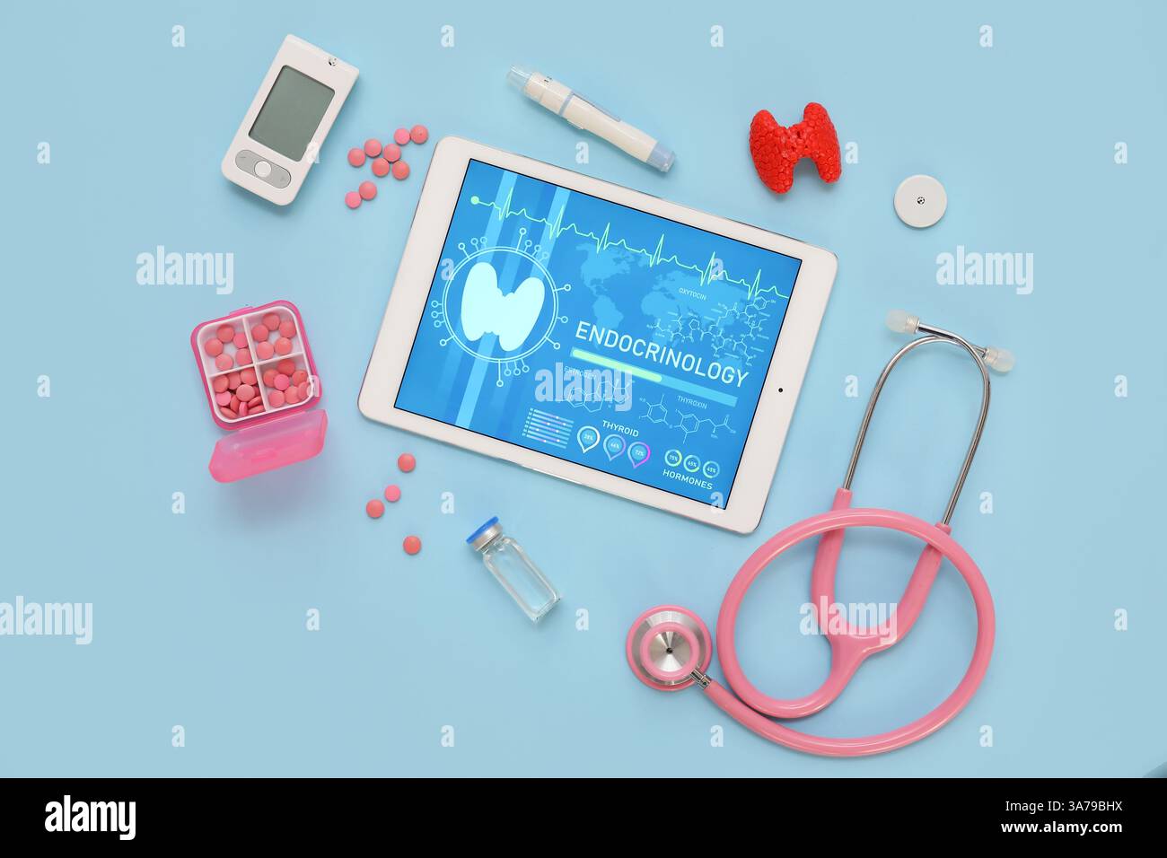 Tablet computer with thyroid gland model, glucometer and stethoscope on ...