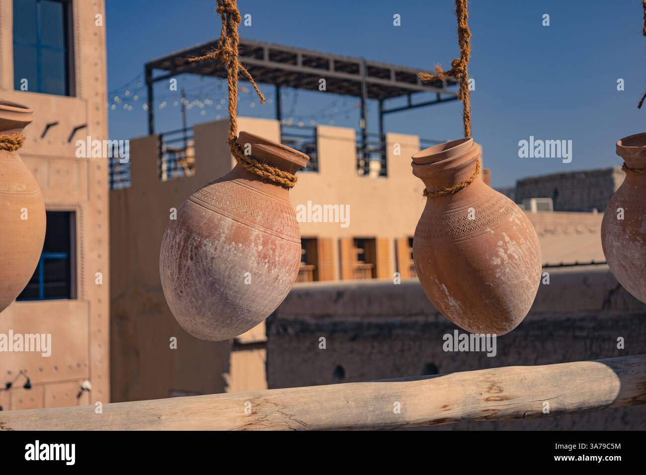 Hanging clay pots in a traditional desert-style setting. Nizwa, Oman ...