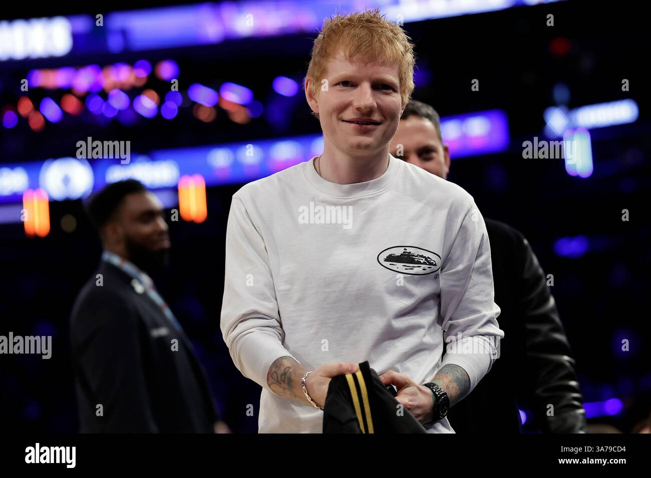 Ed Sheeran reacts walking off the court during the second half of an ...