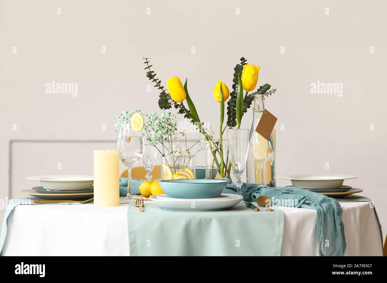 Elegant table setting with beautiful tulip flowers and candles in light ...
