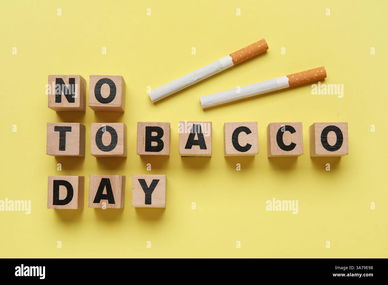 Cubes with text NO TOBACCO DAY and cigarettes on yellow background ...