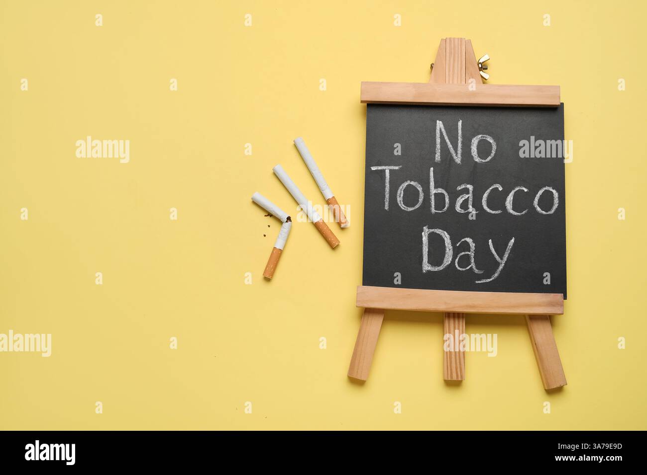 Chalkboard with text NO TOBACCO DAY and cigarettes on yellow background ...
