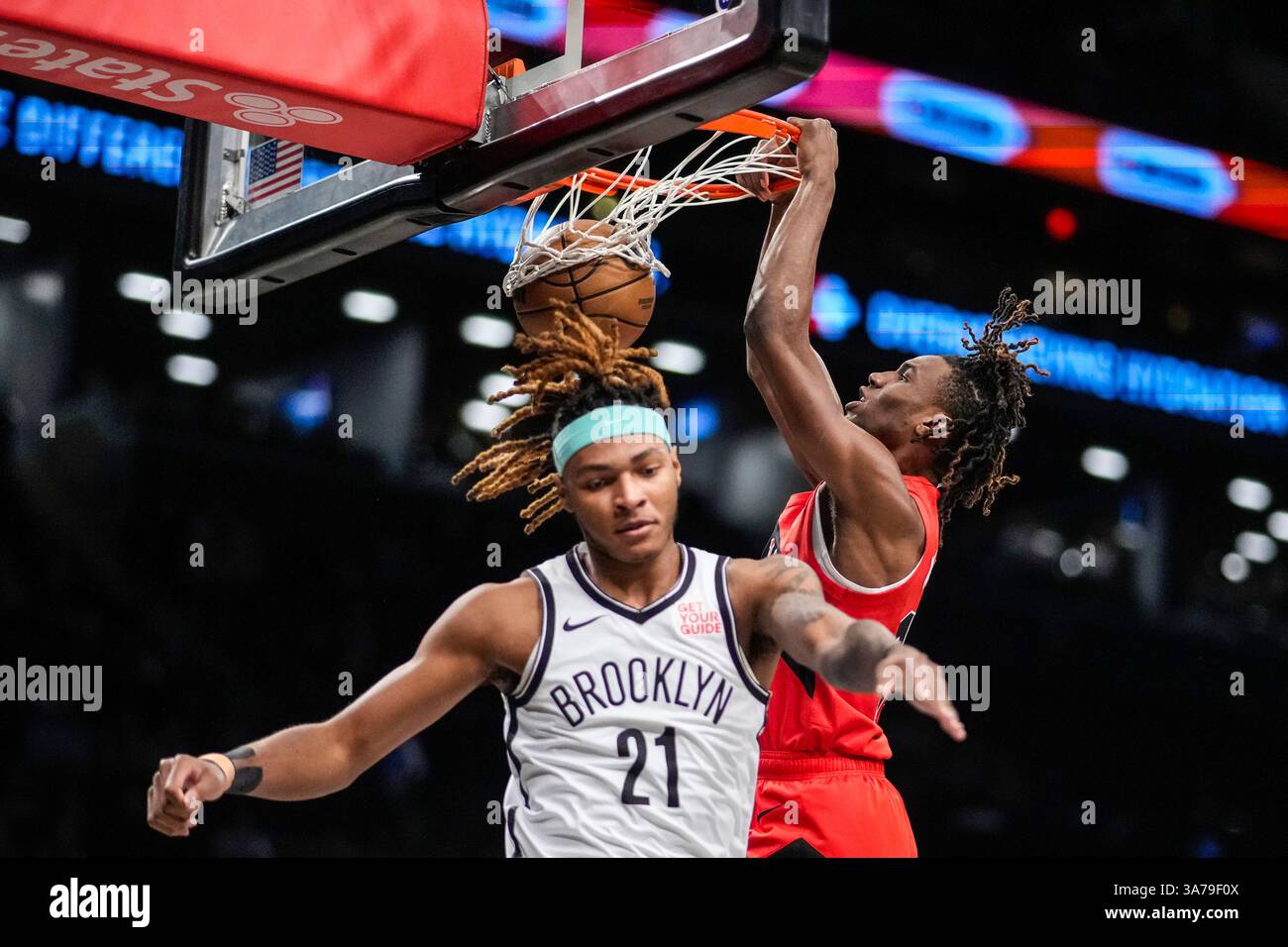 Toronto Raptors guard Ja'Kobe Walter (right) dunks against Brooklyn ...