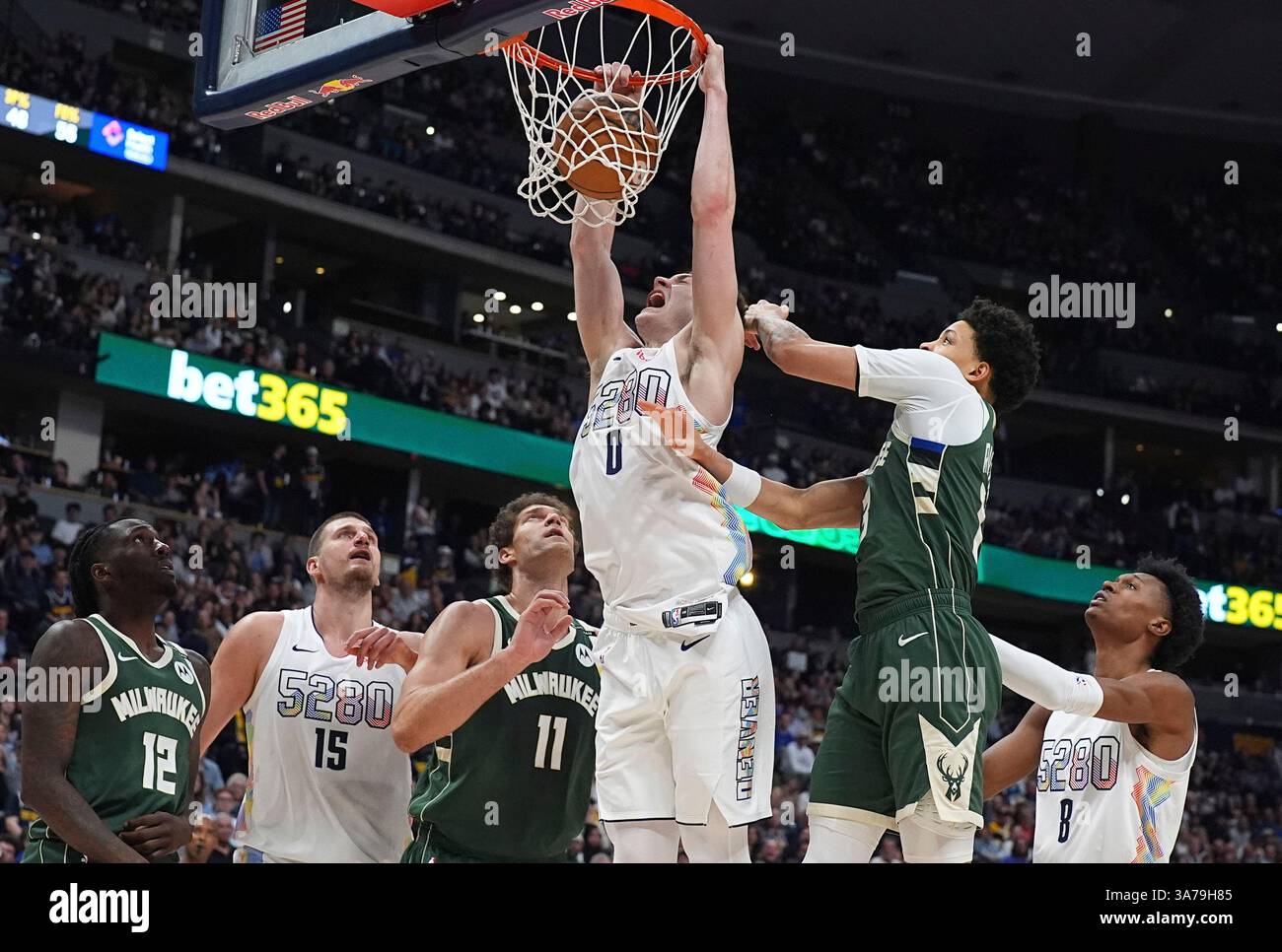 Denver Nuggets guard Christian Braun, front left, dunks the ball for a ...