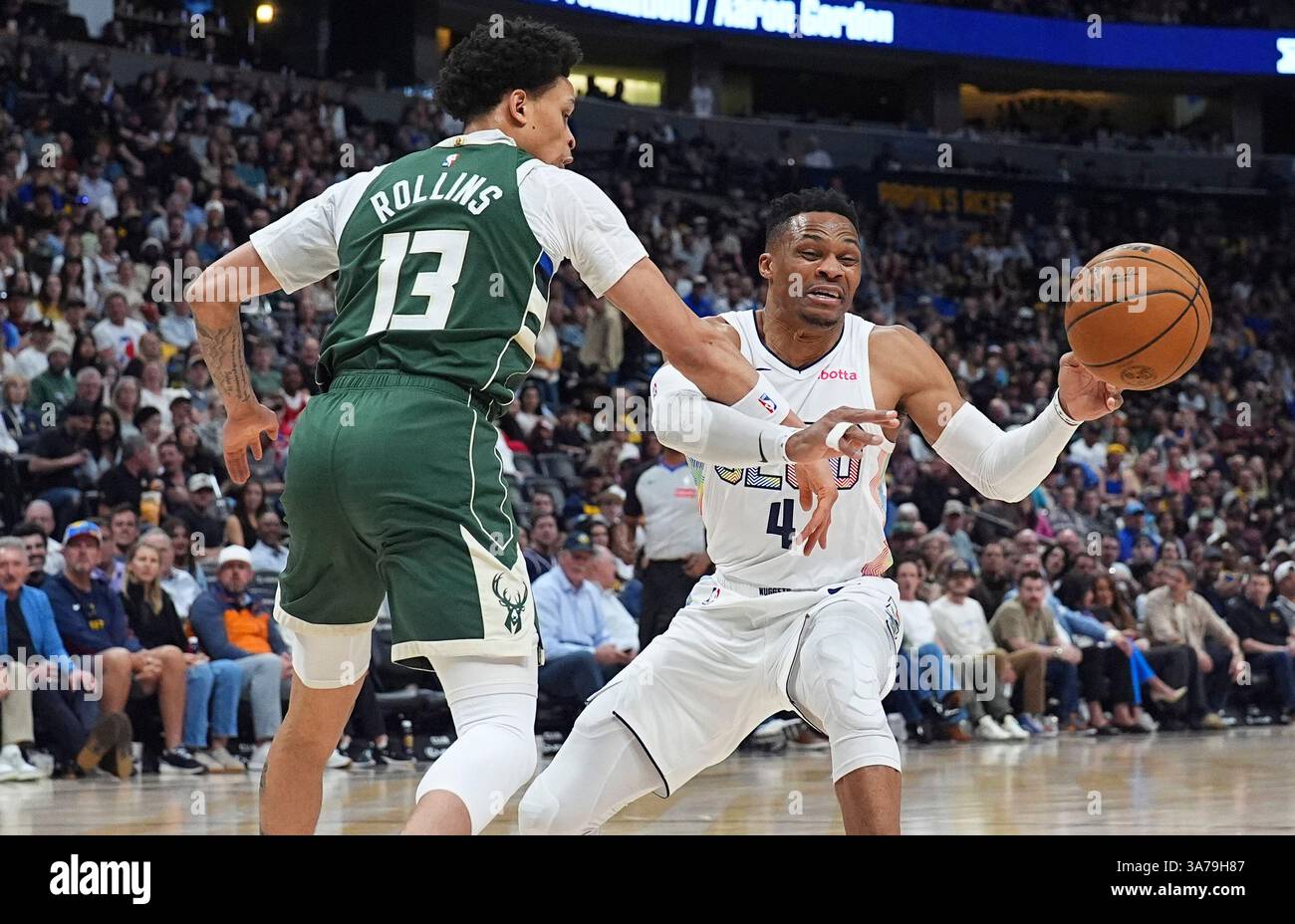Denver Nuggets guard Russell Westbrook, right, loses control of the ...