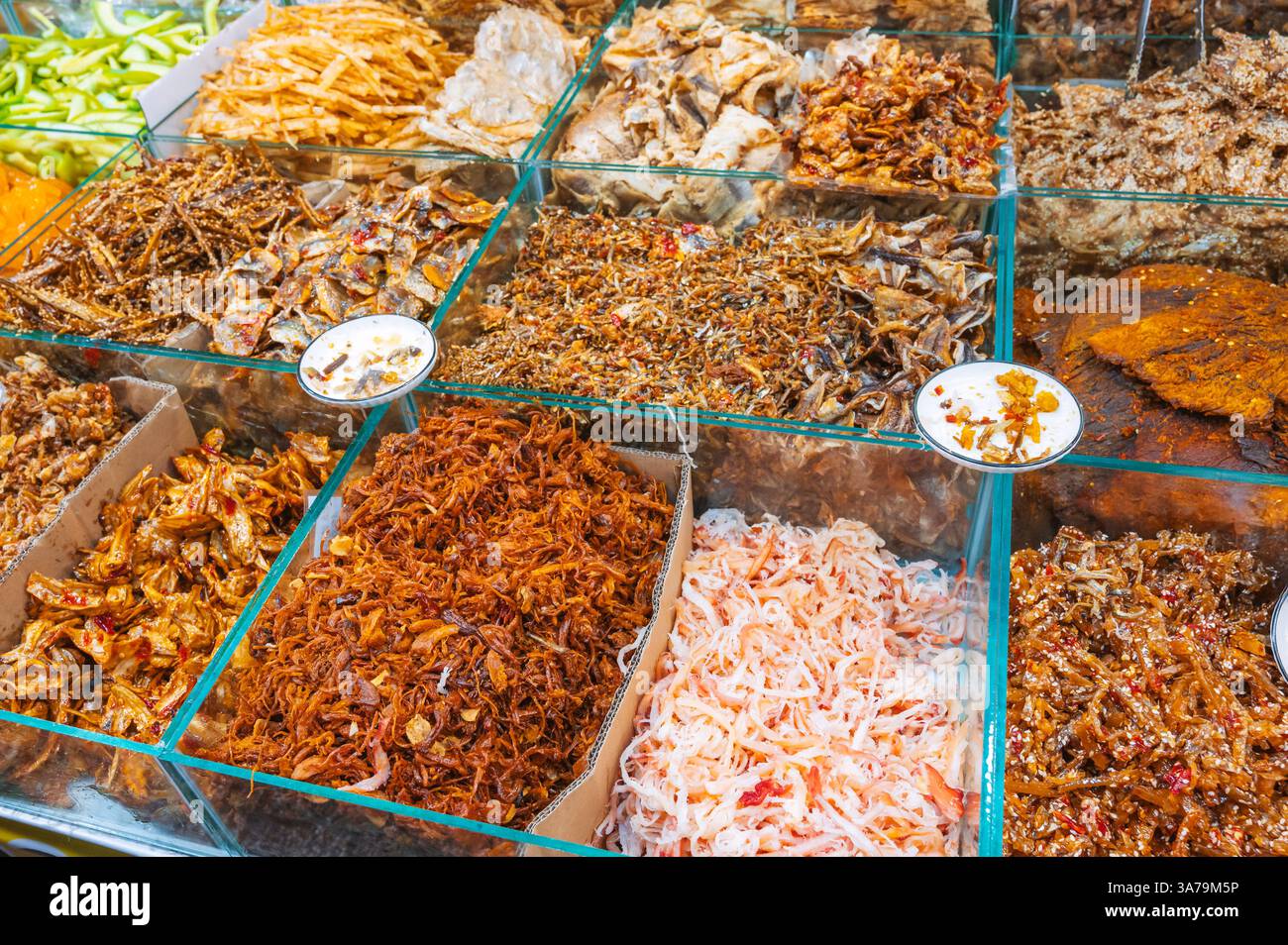 assortment of dried fish and seafood for snacks on the counter at Asian ...